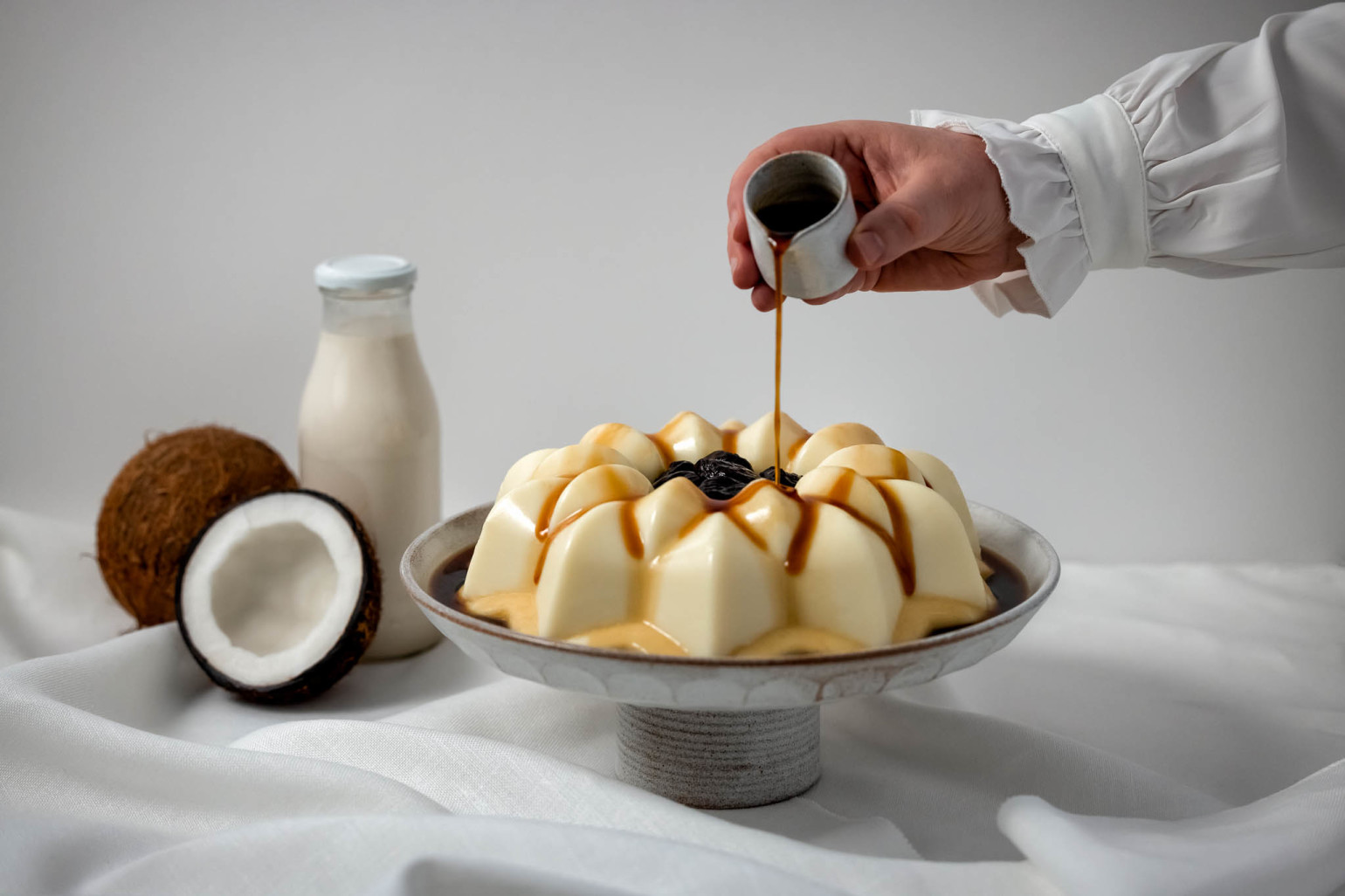 A delicious coconut flan served with prune sauce. · Alice in Gastronomyland